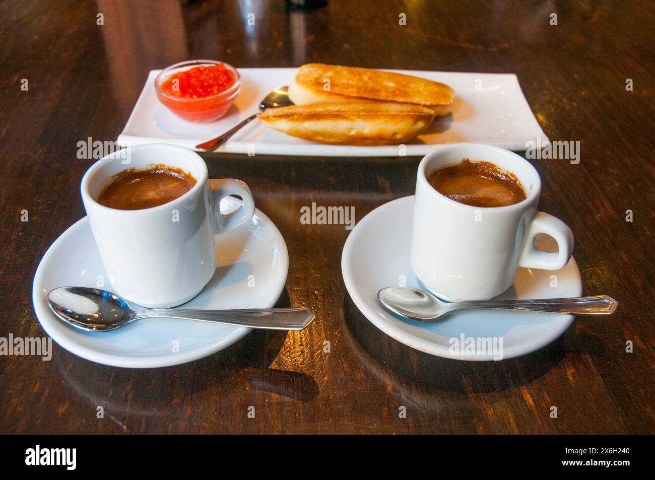 Spanish breakfast: two cups of coffee and bread with olive oil and ...