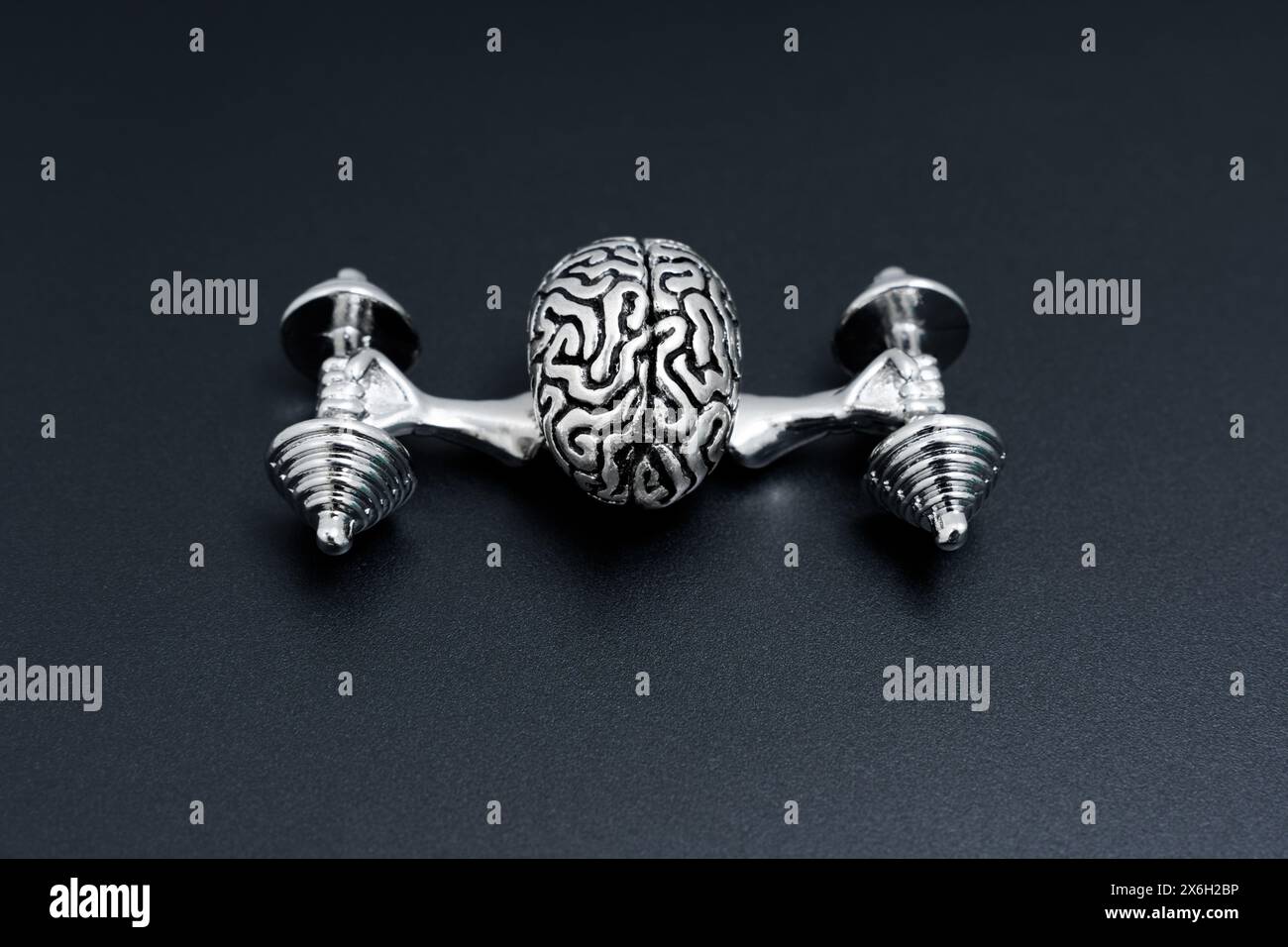 Steel human brain figurine lifting heavy dumbbells with strong arms ...