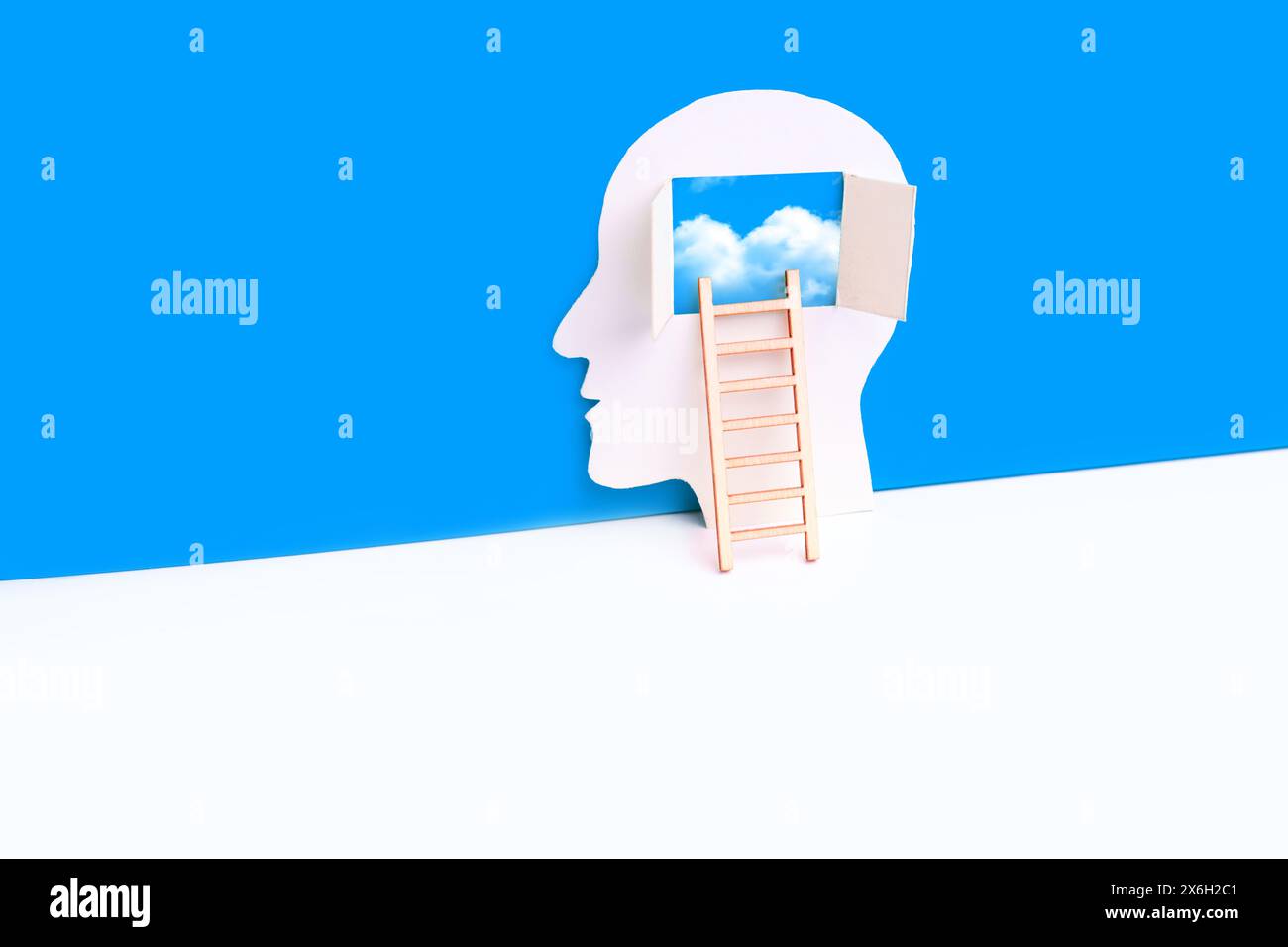 Male head paper cutout with a wooden step ladder leading to the open ...