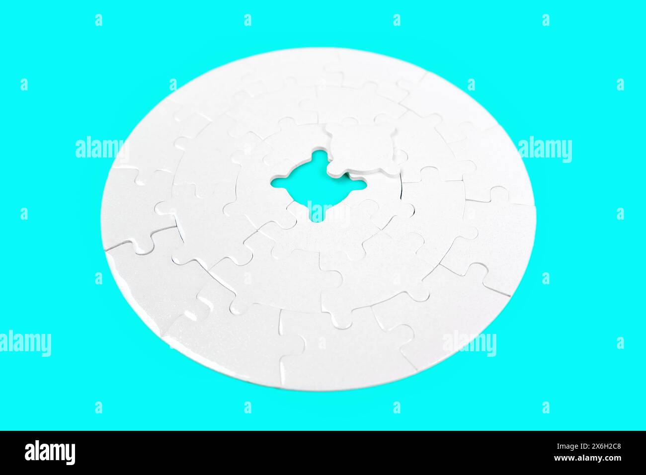 Last piece of a circular jigsaw puzzle awaits placement in the center ...