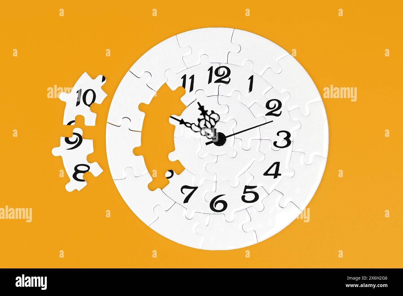 Unfinished puzzle in the form of a clock face, with missing pieces ...