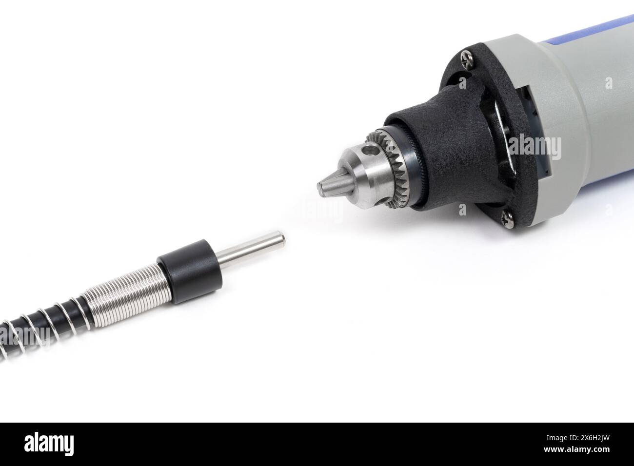 Flex shaft core placed near a mini drill chuck isolated on white ...