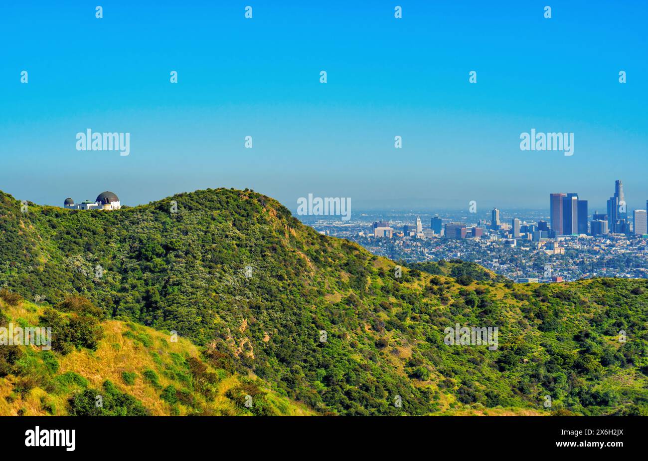 Vast green hill with the iconic Griffith Observatory on top and a ...