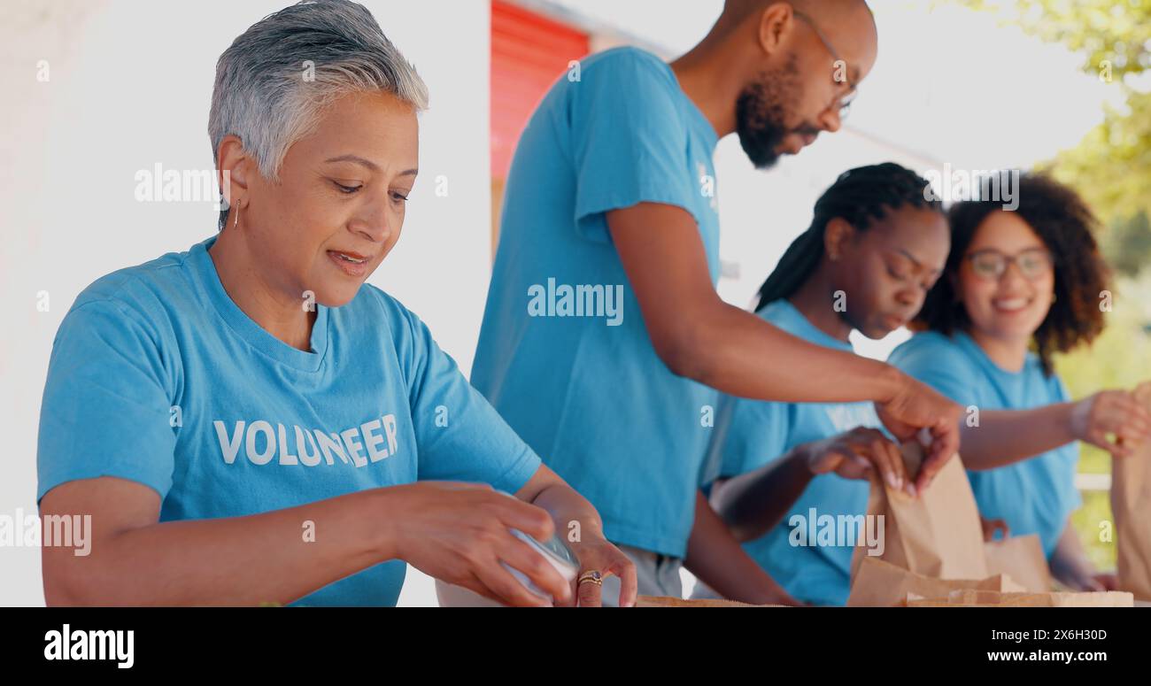People volunteering, packaging food and donation for community service ...