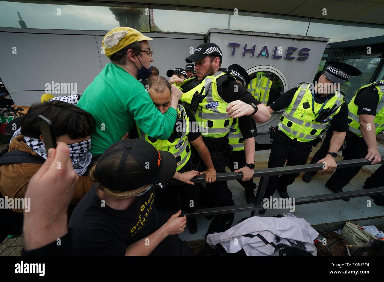 Pro-Palestine campaigners scuffle with police during a protest outside ...