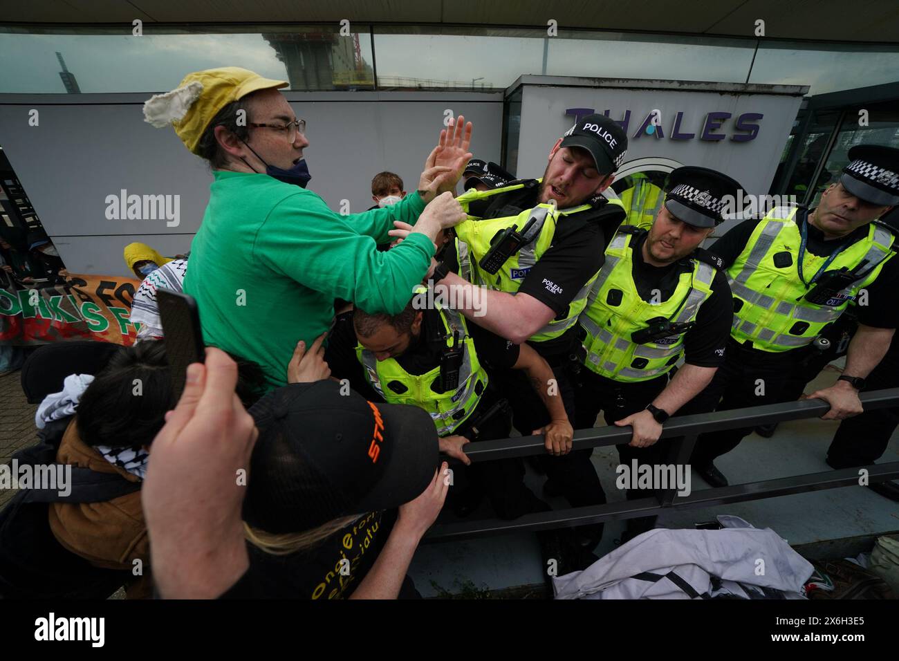 Pro-Palestine campaigners scuffle with police during a protest outside ...