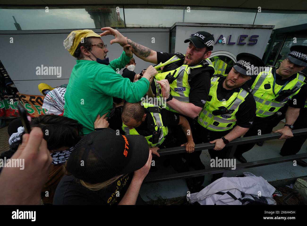 Pro-Palestine campaigners scuffle with police during a protest outside ...
