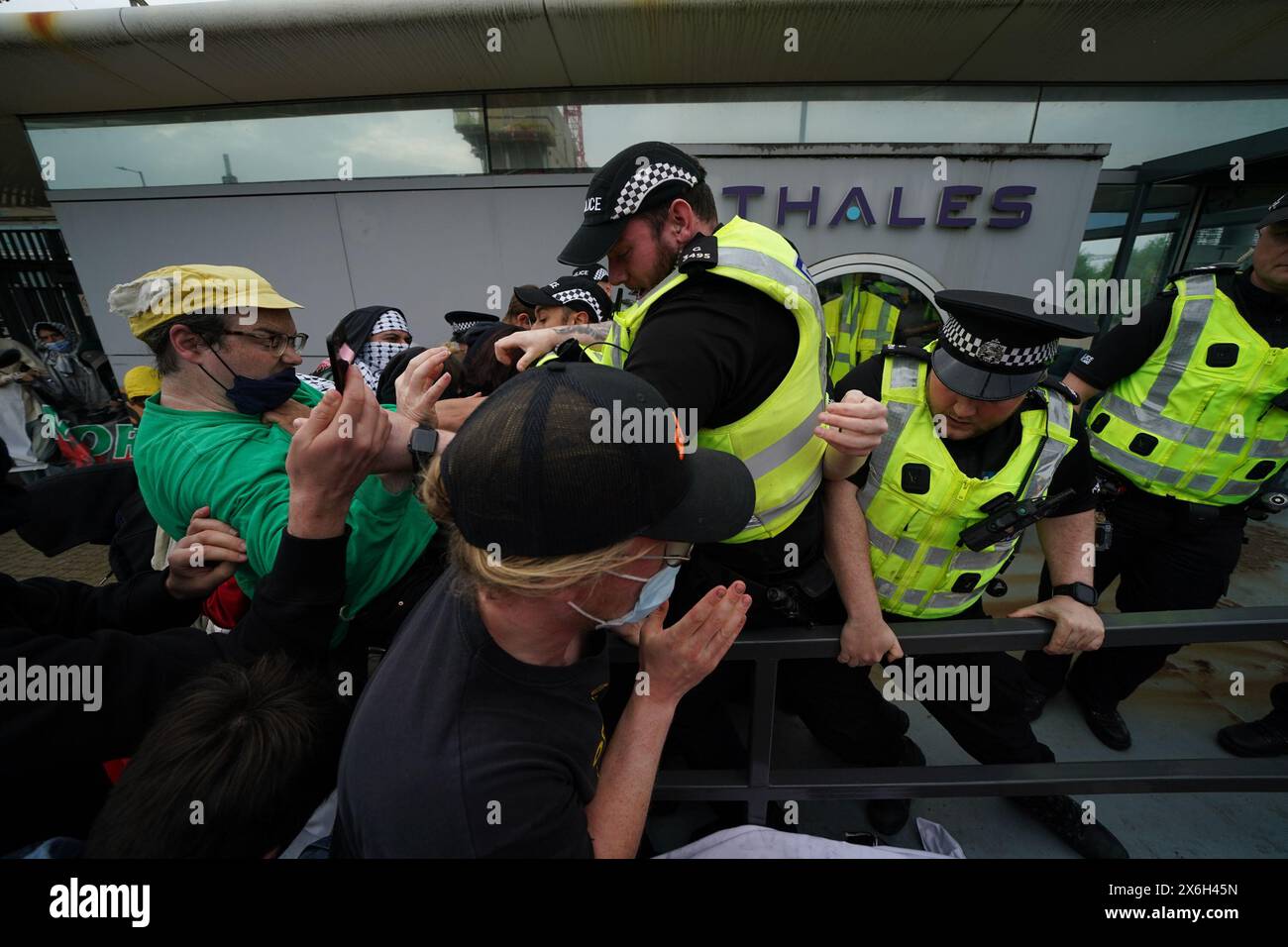 Pro-Palestine campaigners scuffle with police during a protest outside ...