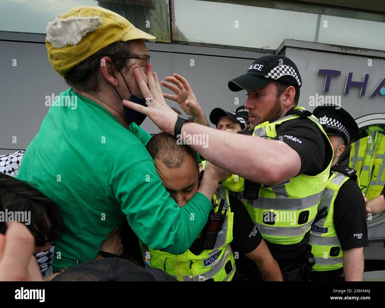 Pro-Palestine campaigners scuffle with police during a protest outside ...