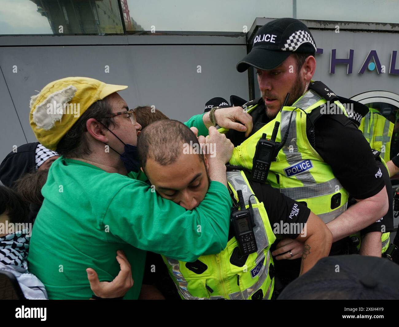 Pro-Palestine campaigners scuffle with police during a protest outside ...