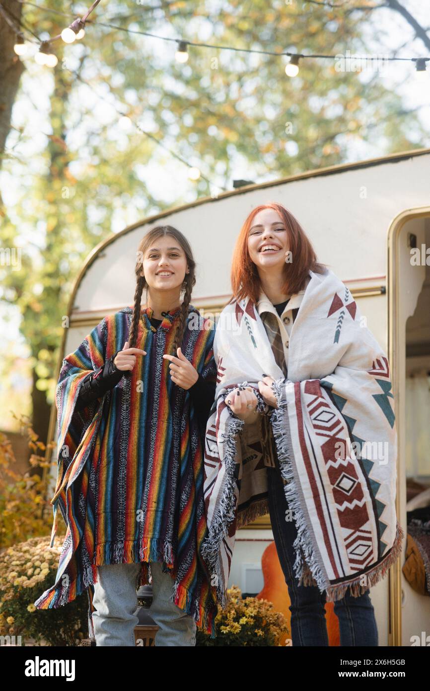 Two hip girls showcase their hippie-inspired outfits against the ...