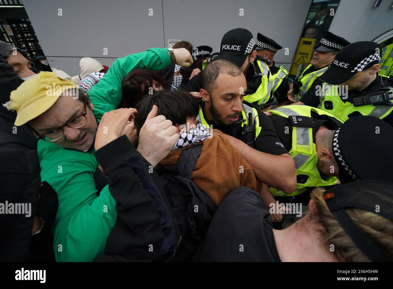 Pro-Palestine campaigners scuffle with police during a protest outside ...