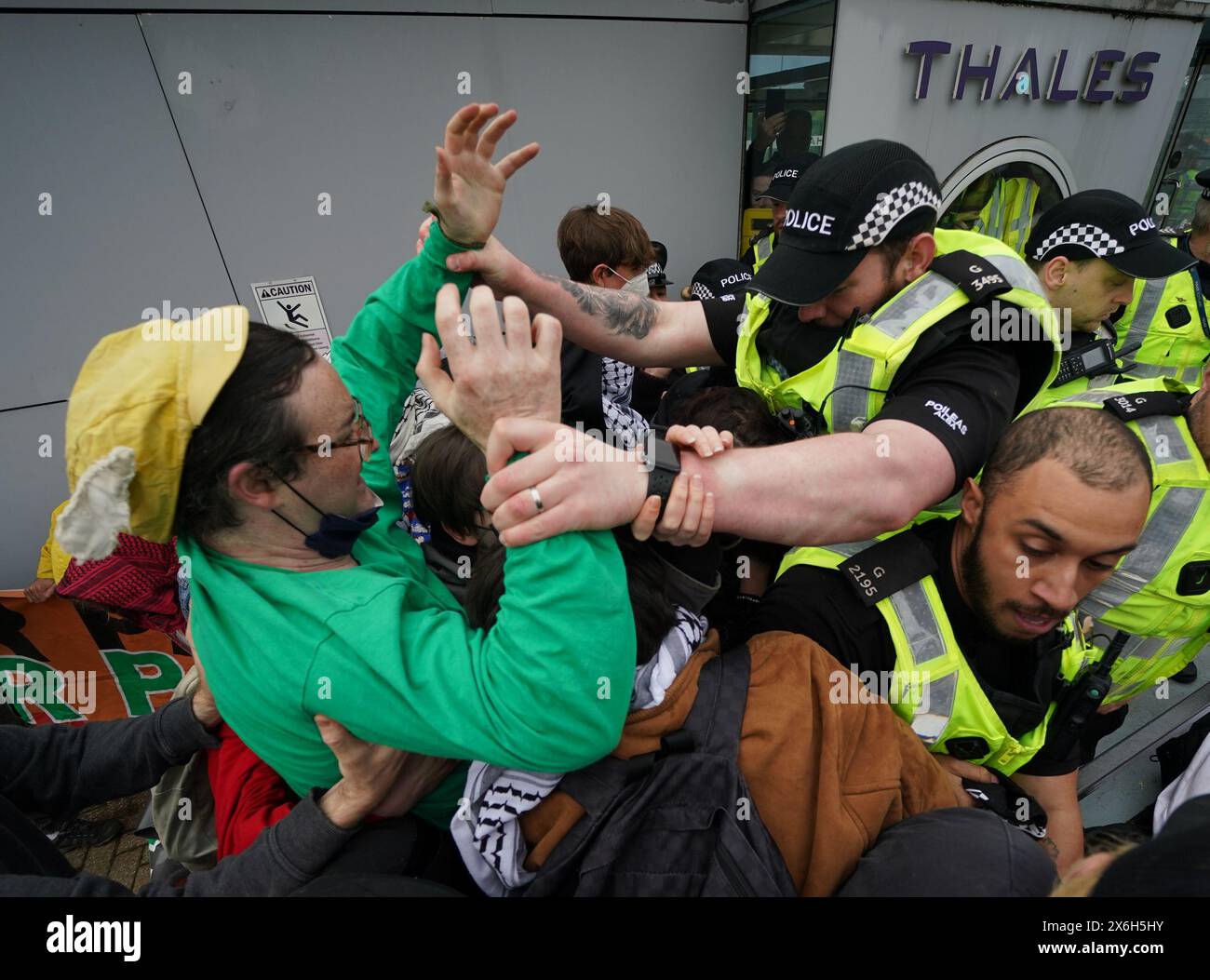 Pro-Palestine campaigners scuffle with police during a protest outside ...