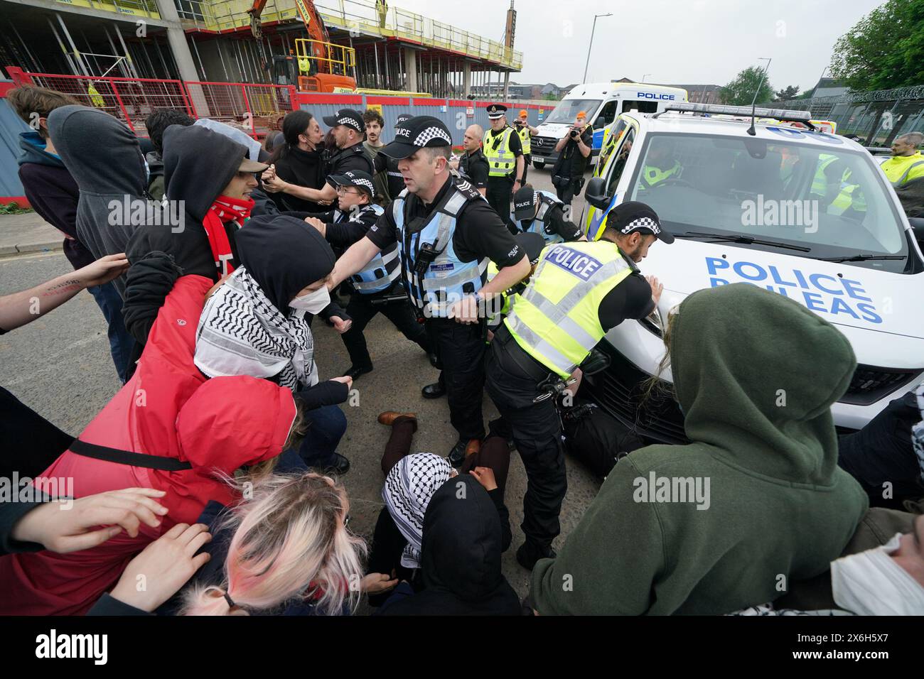 Pro-Palestine campaigners scuffle with police as they surround a police ...
