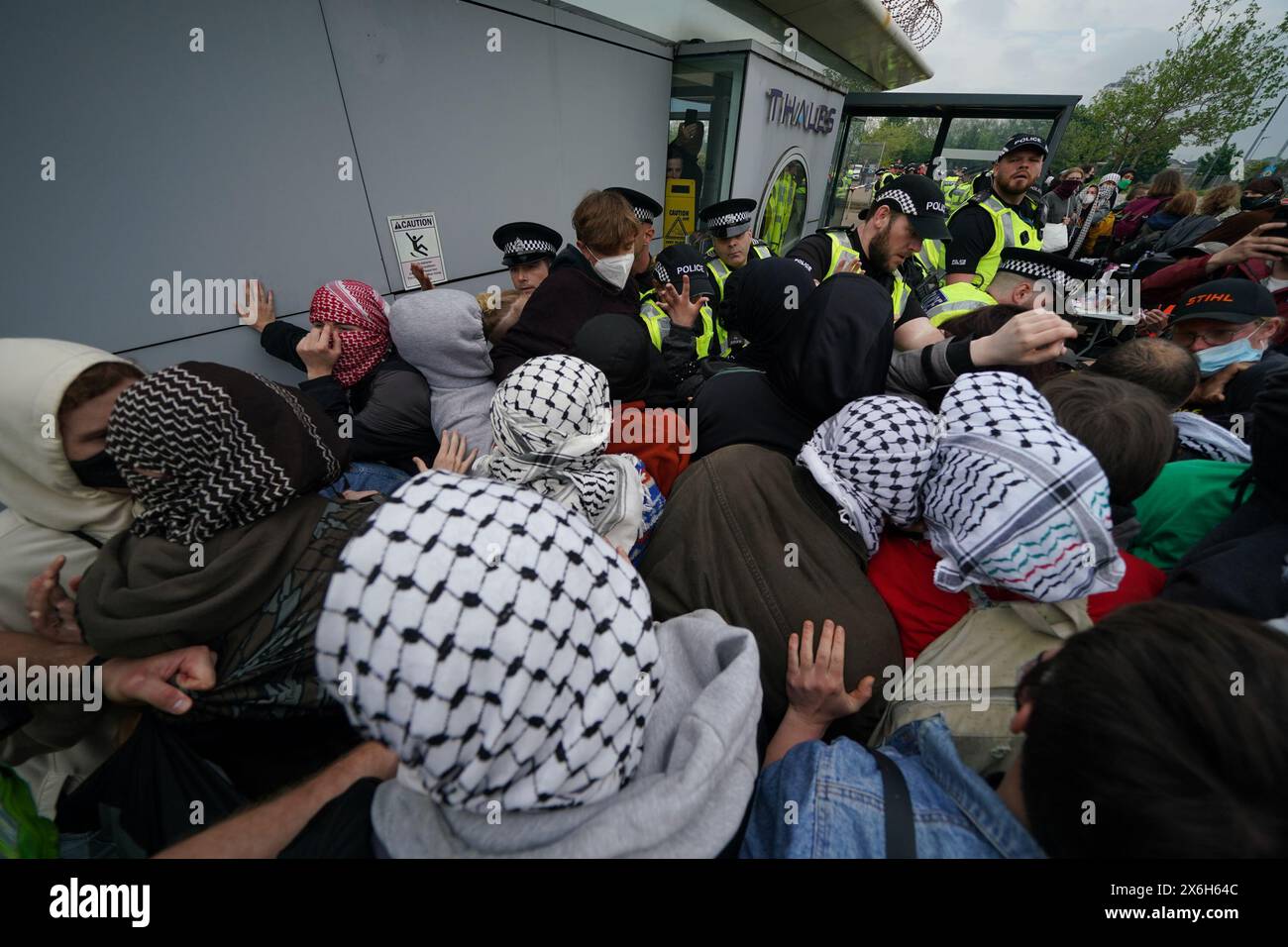 Pro-Palestine campaigners are pushed back by police during a protest ...