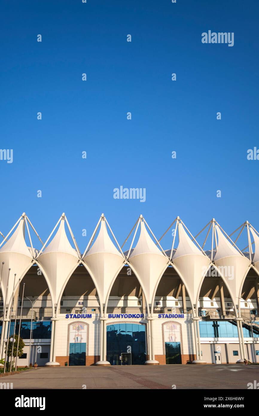 Exterior view of the front of the stadium with sign and sail-like ...