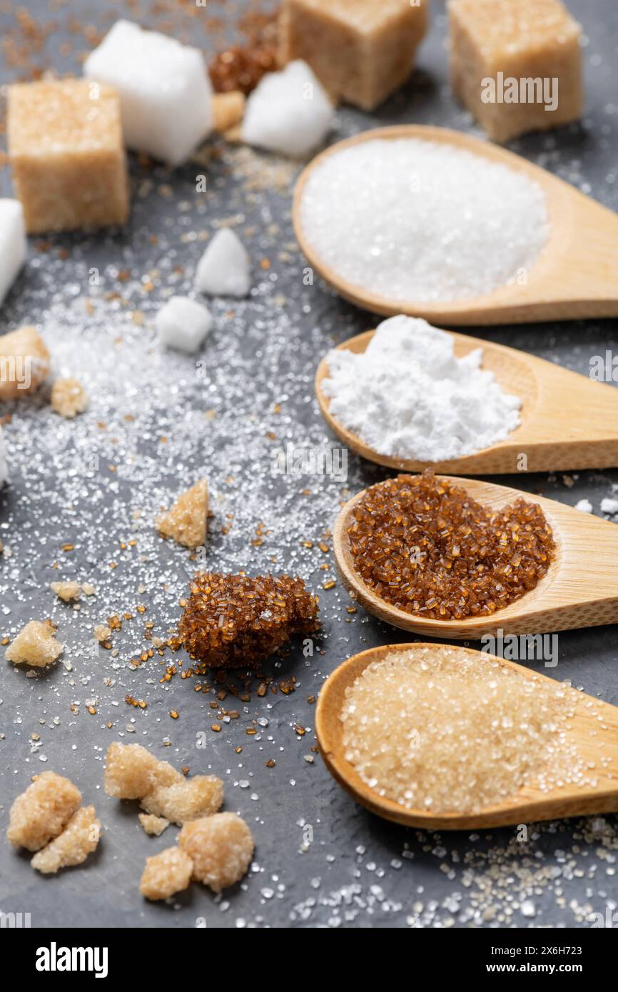 on a gray background, different types of refined and lump sugar, white ...