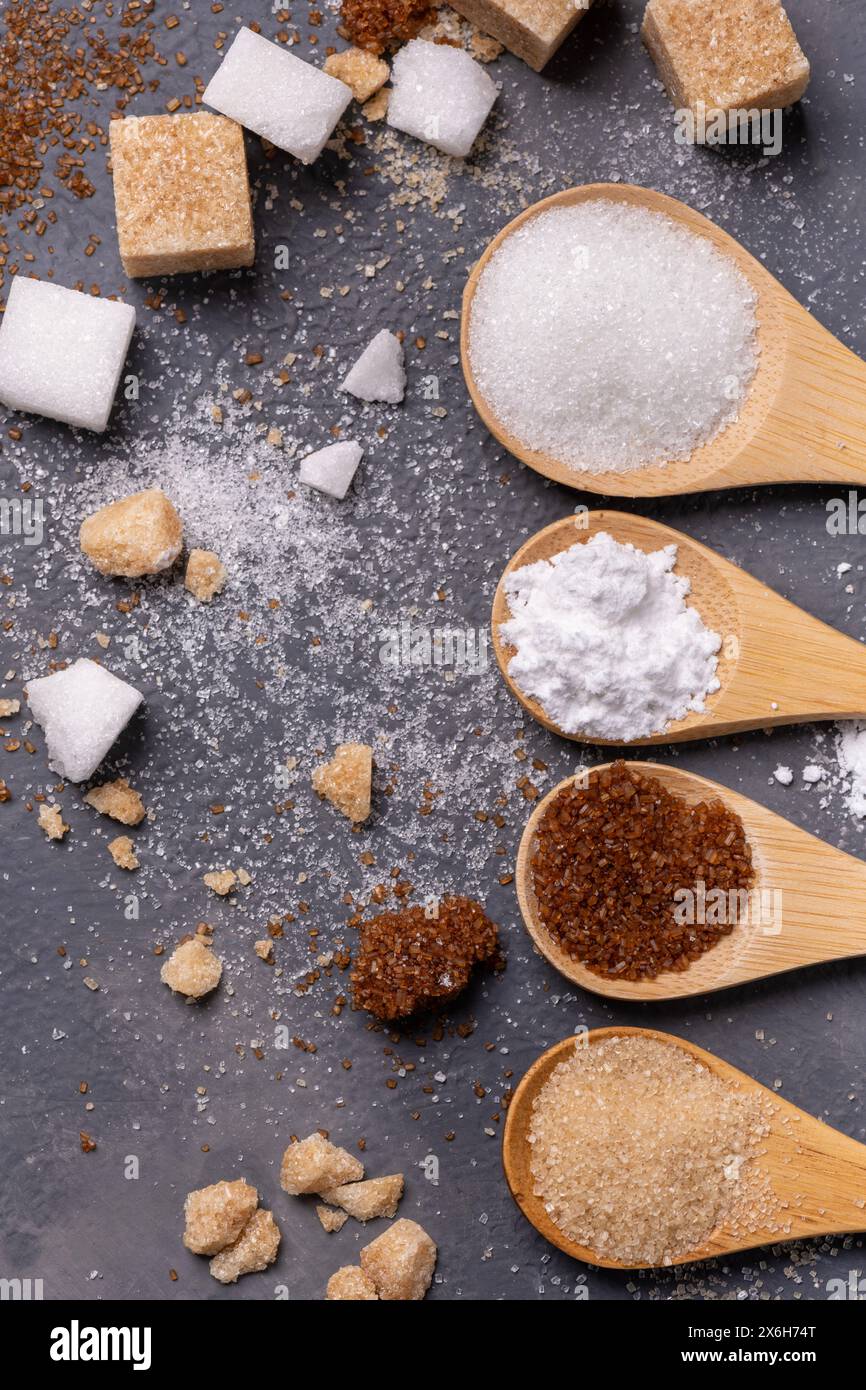 on a gray background, different types of refined and lump sugar, white ...