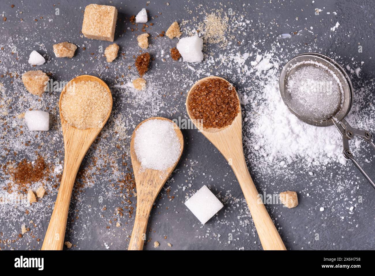 on a gray background, different types of refined and lump sugar, white ...