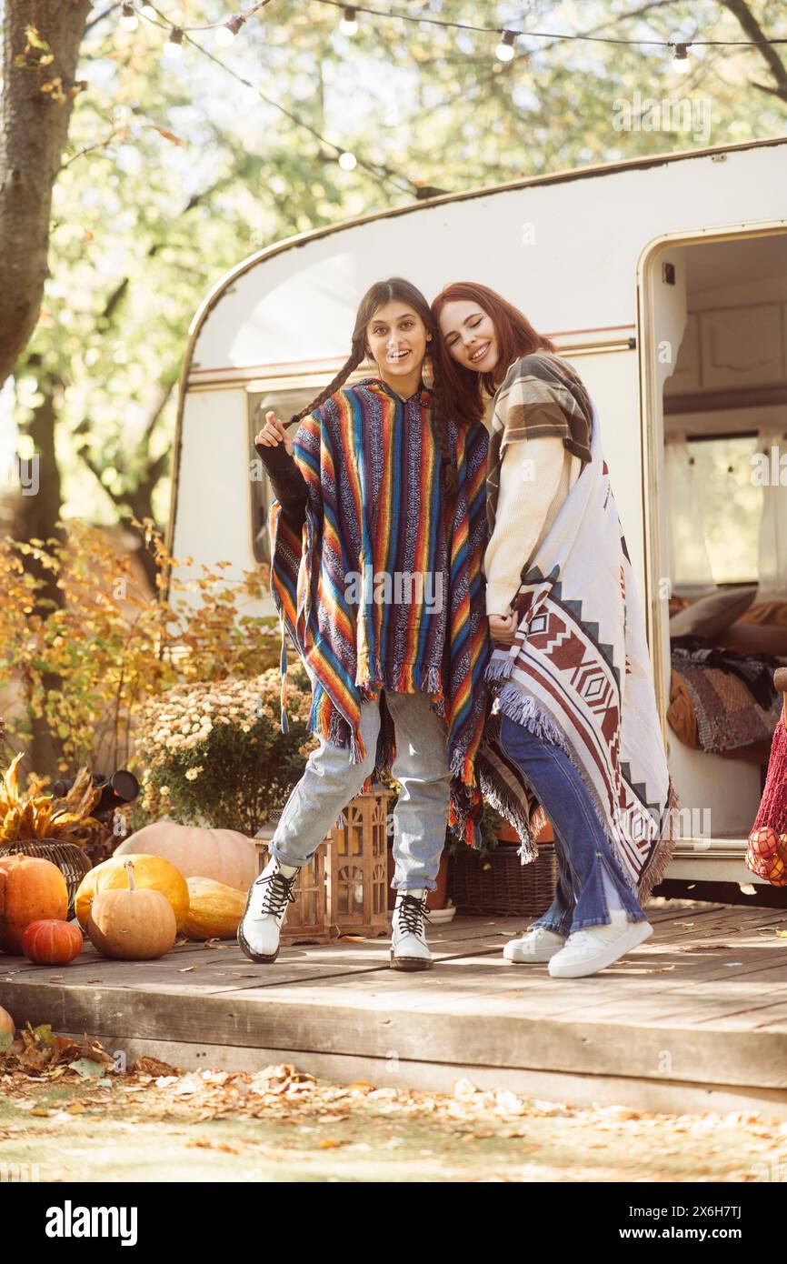 Two hip girls showcase their hippie-inspired outfits against the ...
