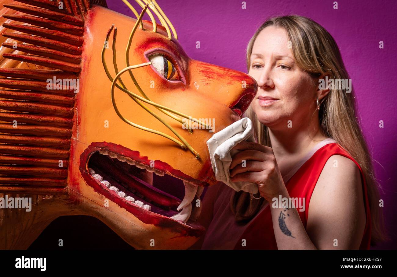 Kat Baxter curator of archaeology, cleans a lion-shaped coffin that was ...