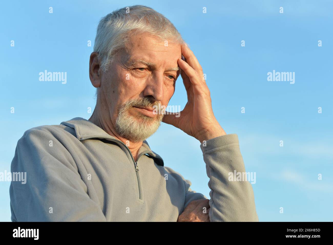 Portrait of a serious senior man on sky background Stock Photo - Alamy