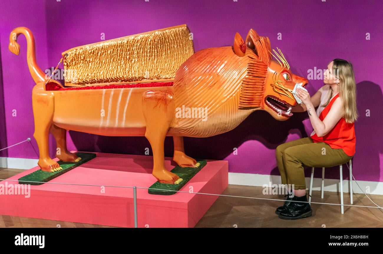 Kat Baxter curator of archaeology, cleans a lion-shaped coffin that was ...