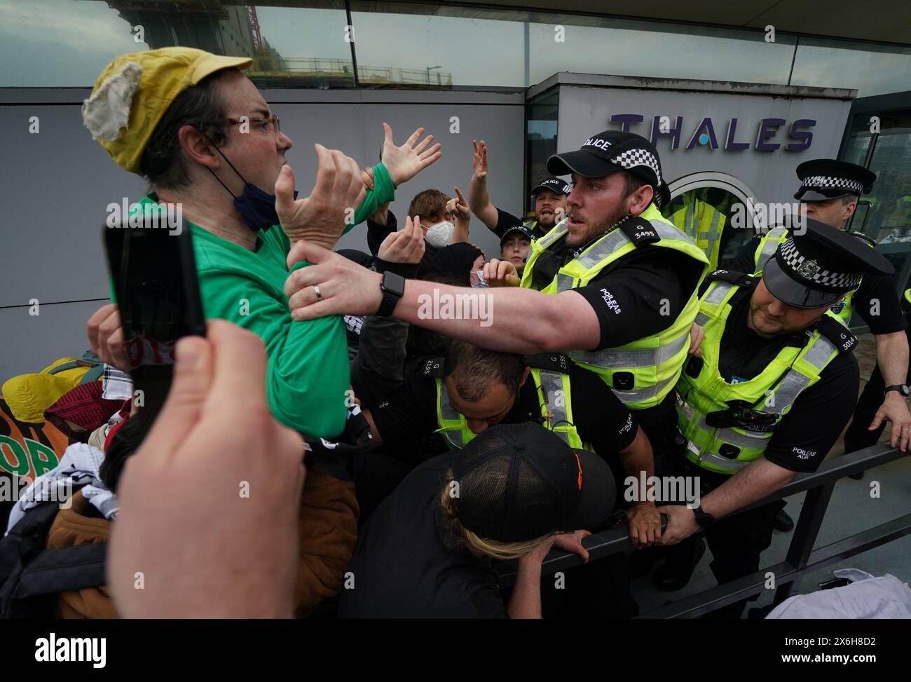 Pro-Palestine campaigners scuffle with police during a protest outside ...