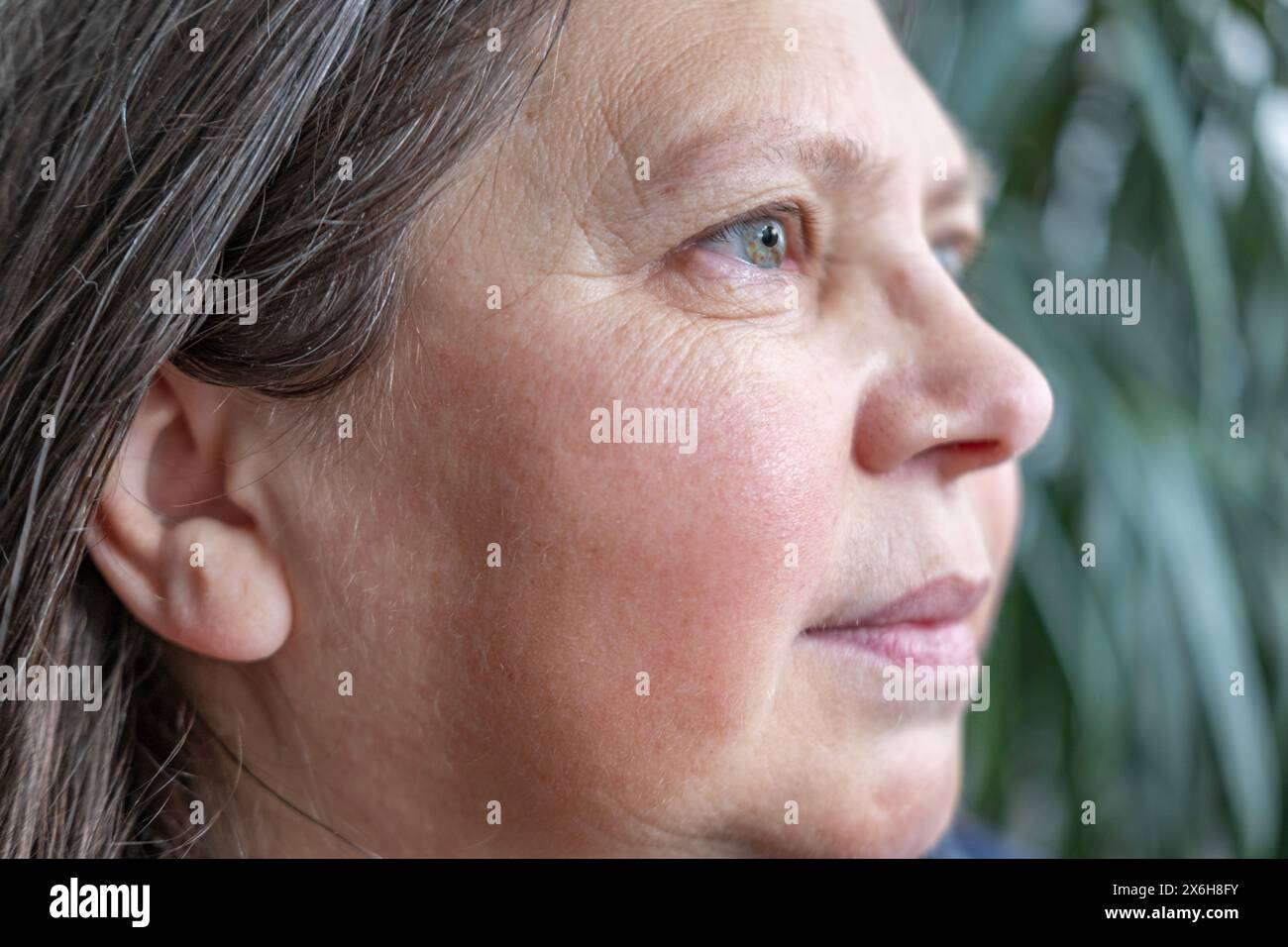 Caucasian positive 50-year-old attractive woman looking at camera ...