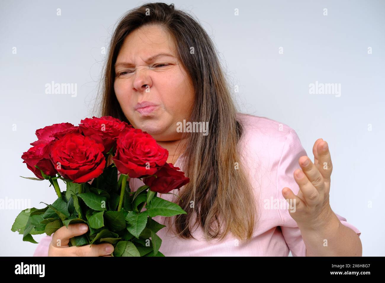 bouquet of flowers, red roses, middle-aged woman 50 years old with ...