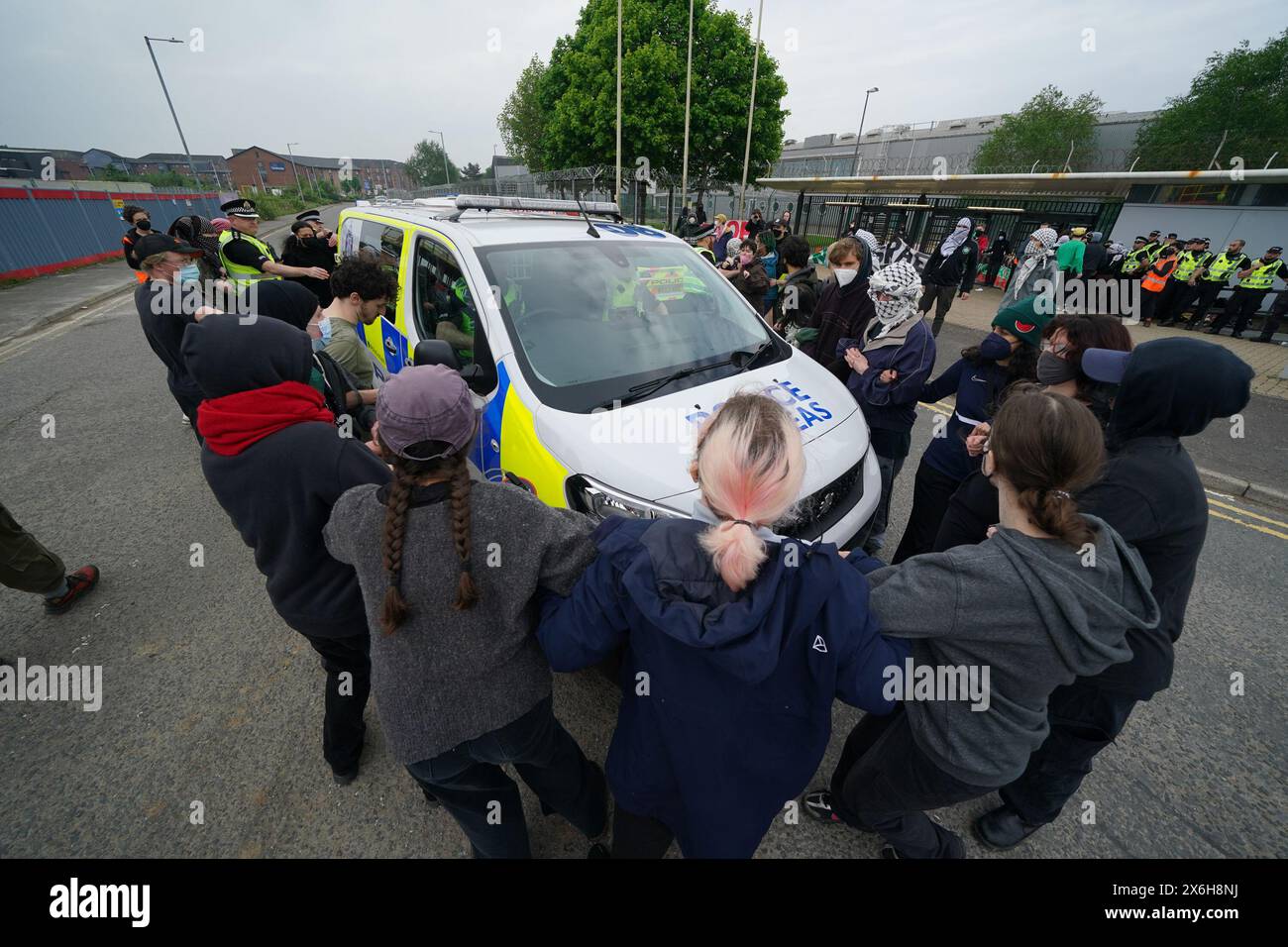 Pro-Palestine campaigners surround a police vehicle during a protest ...