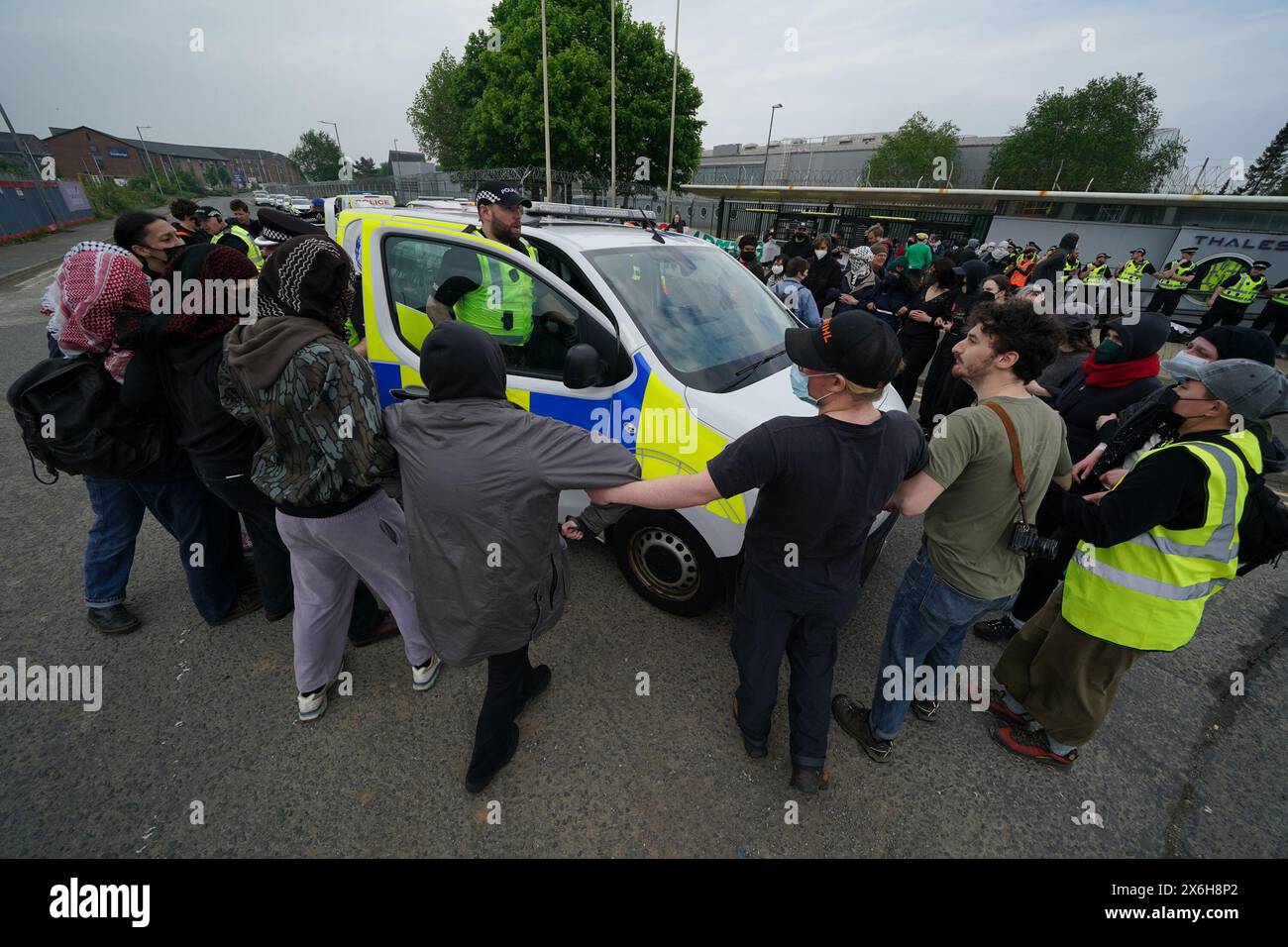 Pro-Palestine campaigners surround a police vehicle during a protest ...