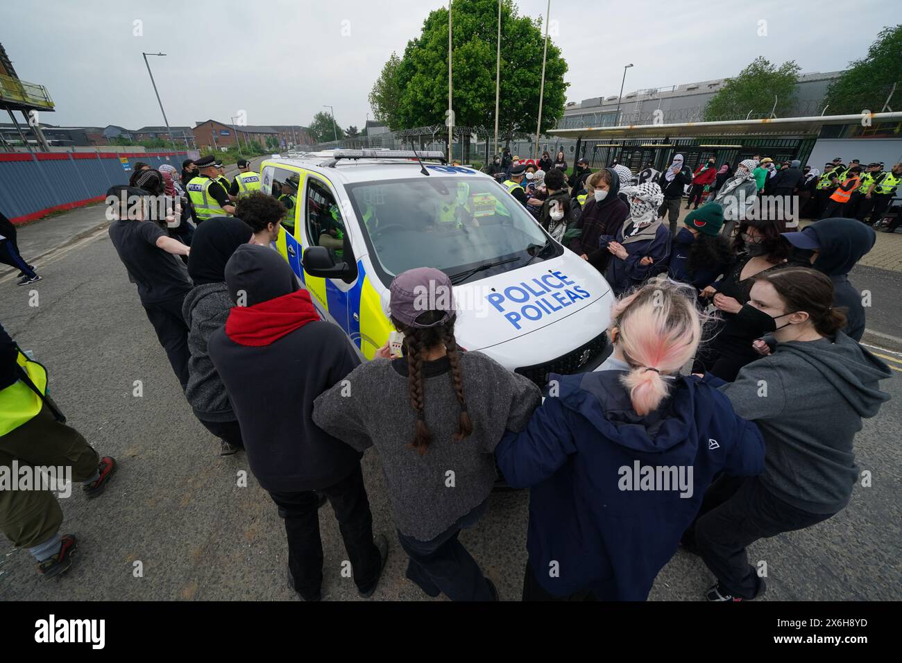 Pro-Palestine campaigners surround a police vehicle during a protest ...