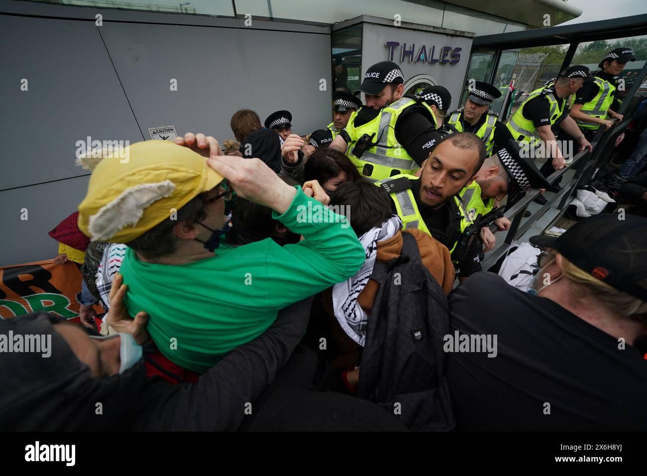 Pro-Palestine campaigners scuffle with police during a protest outside ...