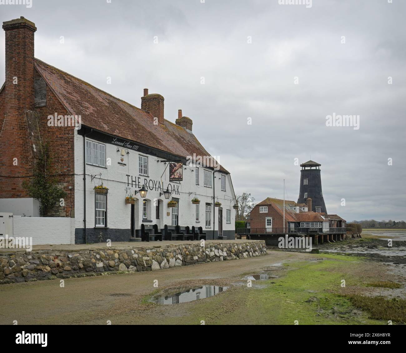 The Royal Oak public house and Langstone Mill on the shoreline at the ...
