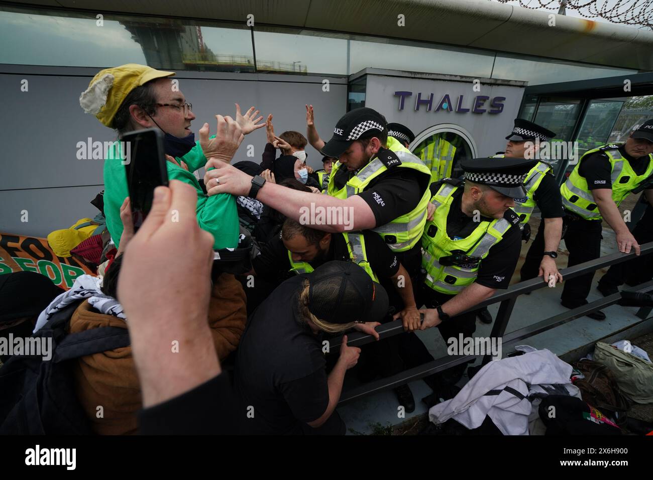 Pro-Palestine campaigners scuffle with police during a protest outside ...