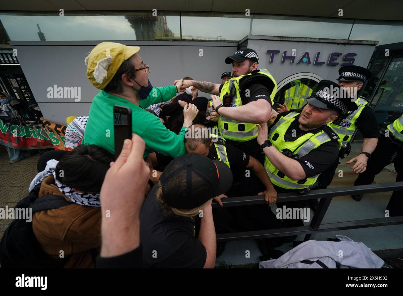 Pro-Palestine campaigners scuffle with police during a protest outside ...