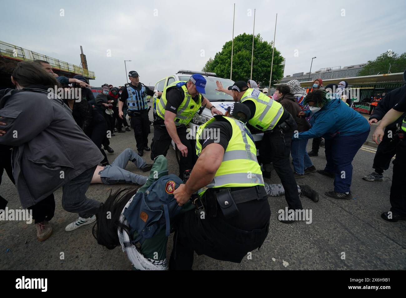Pro-Palestine campaigners are removed by police during a protest ...
