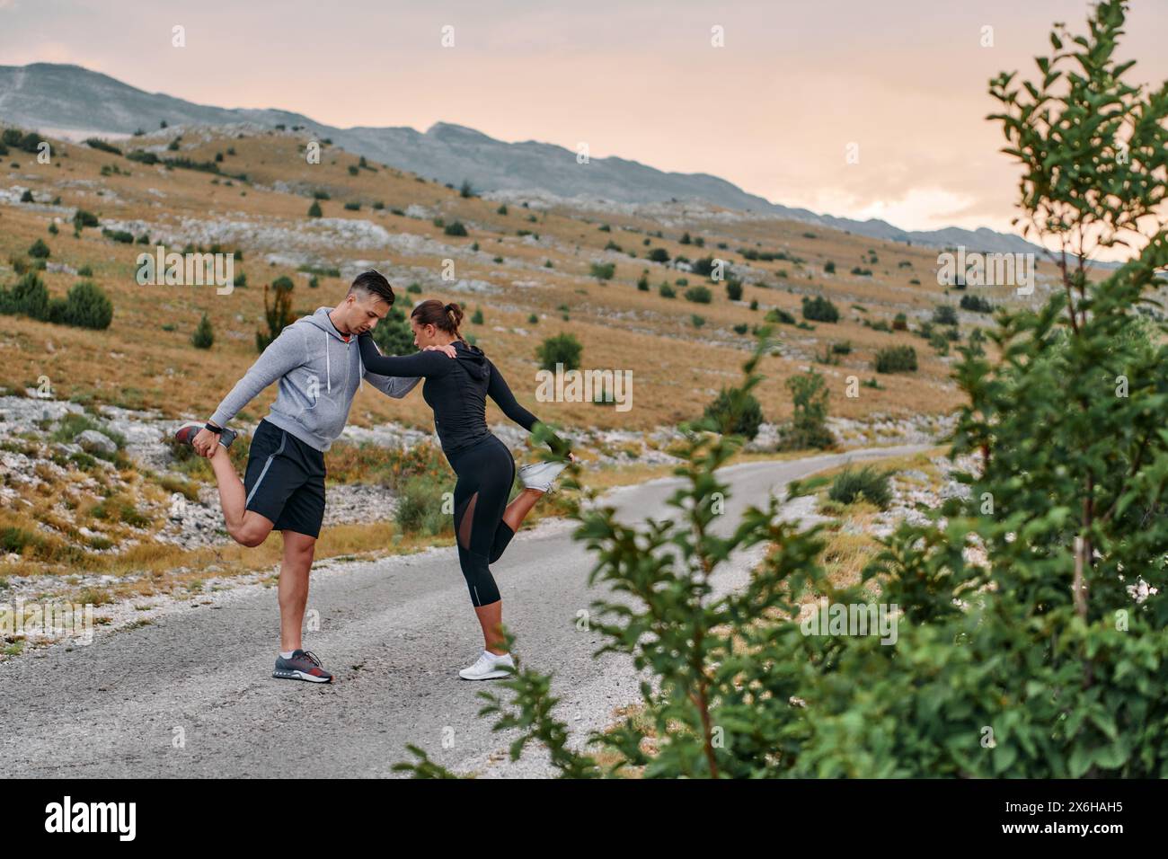 A Romantic Couple Stretching Down After a Run Stock Photo - Alamy