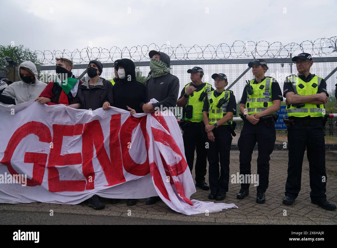 Pro-Palestine campaigners unfurl a banner during a protest outside the ...