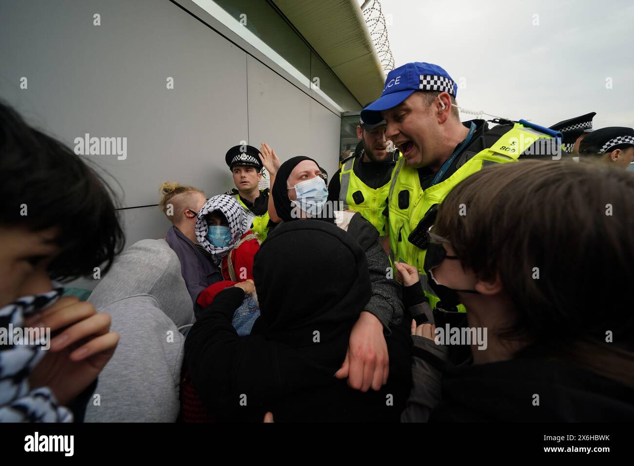 Pro-Palestine campaigners are pushed back by police during a protest ...