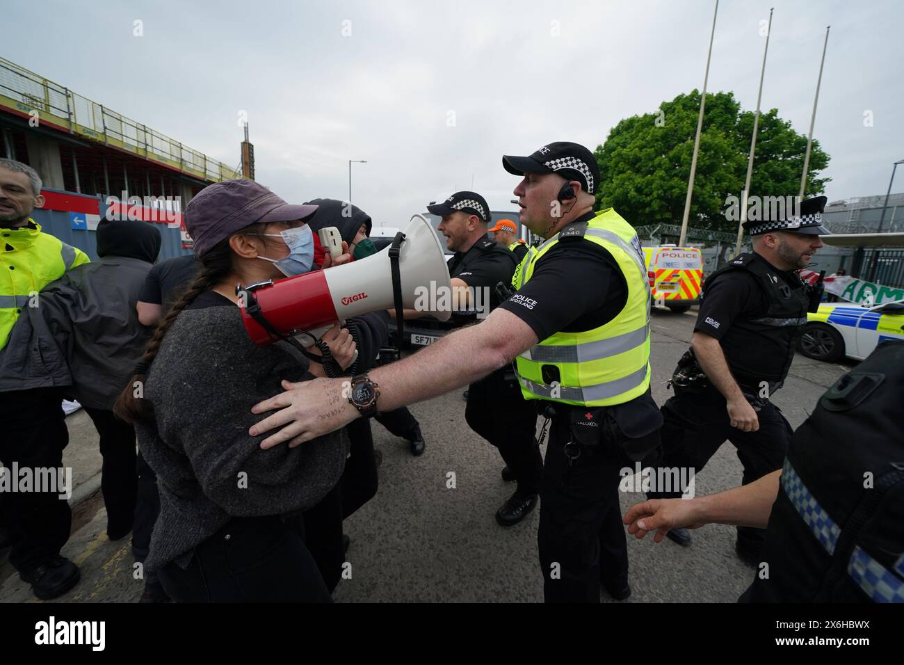 Pro-Palestine campaigners are pushed back by police during a protest ...