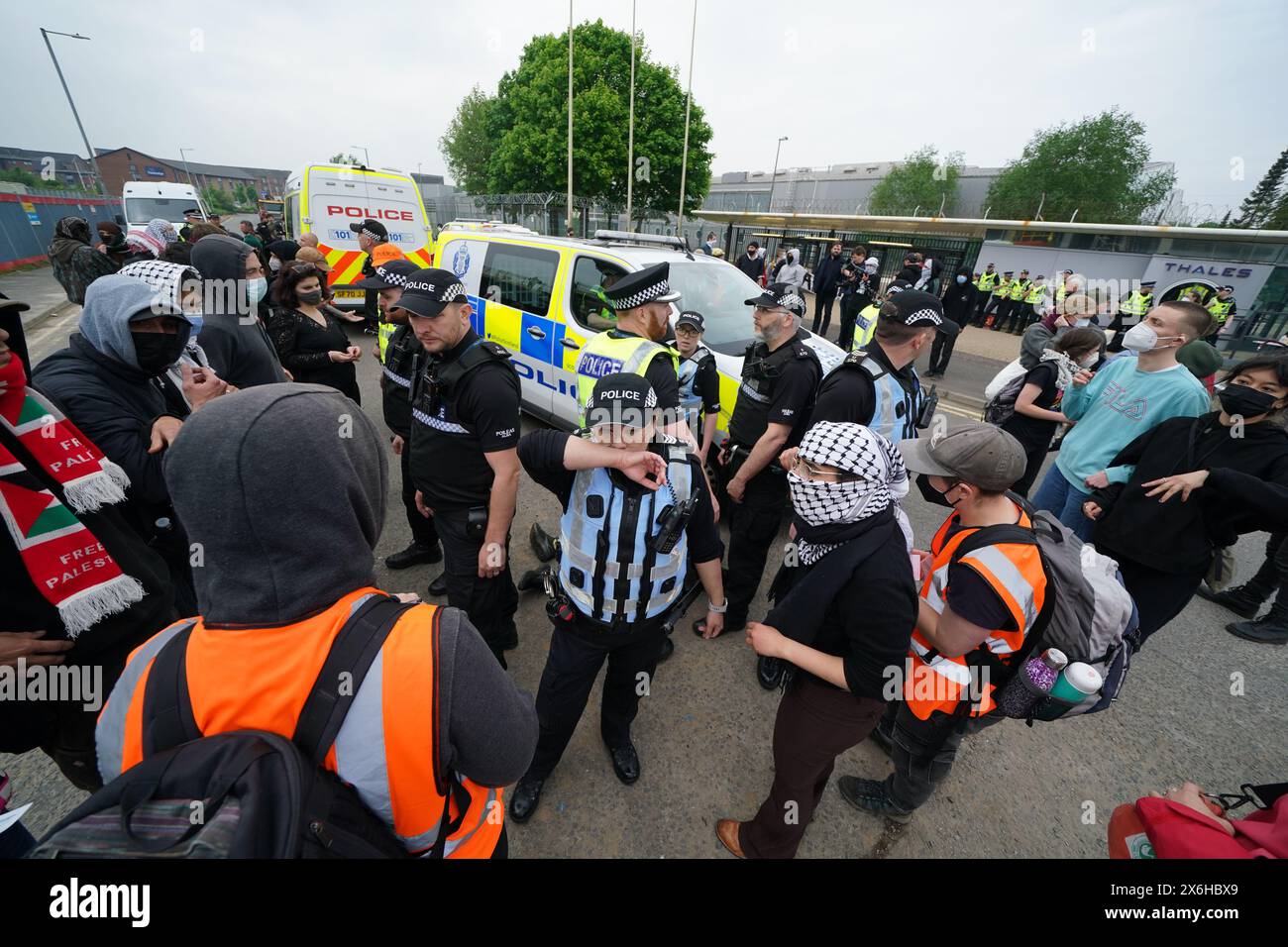 Pro-Palestine campaigners are held back by police during a protest ...