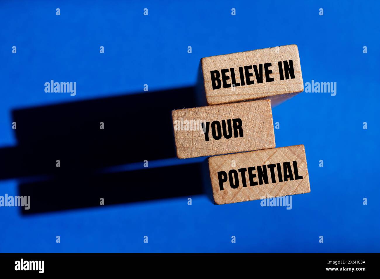 Believe in your potential words written on wooden blocks with blue ...