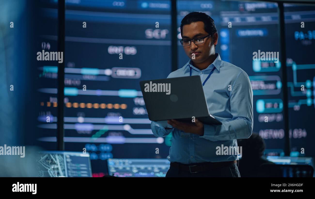 Young Multiethnic Male Government Employee Uses Laptop Computer in ...