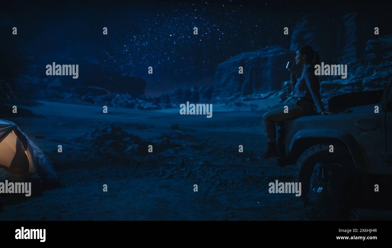 Female Traveler Sitting on Her Off Road SUV hood Watching Night Sky ...