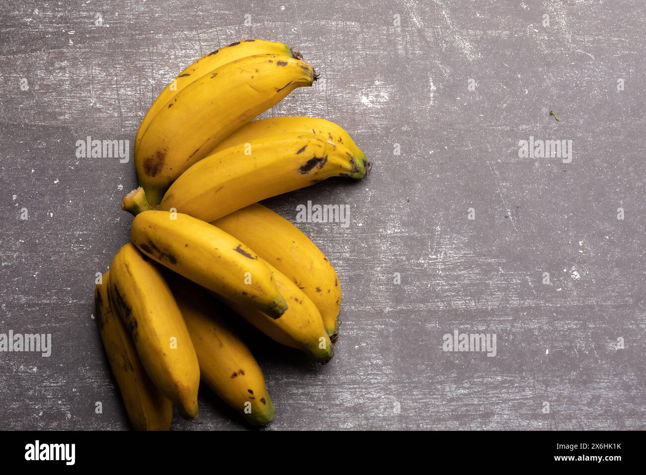 bananas in bunches, on a gray background, fresh bananas Stock Photo - Alamy