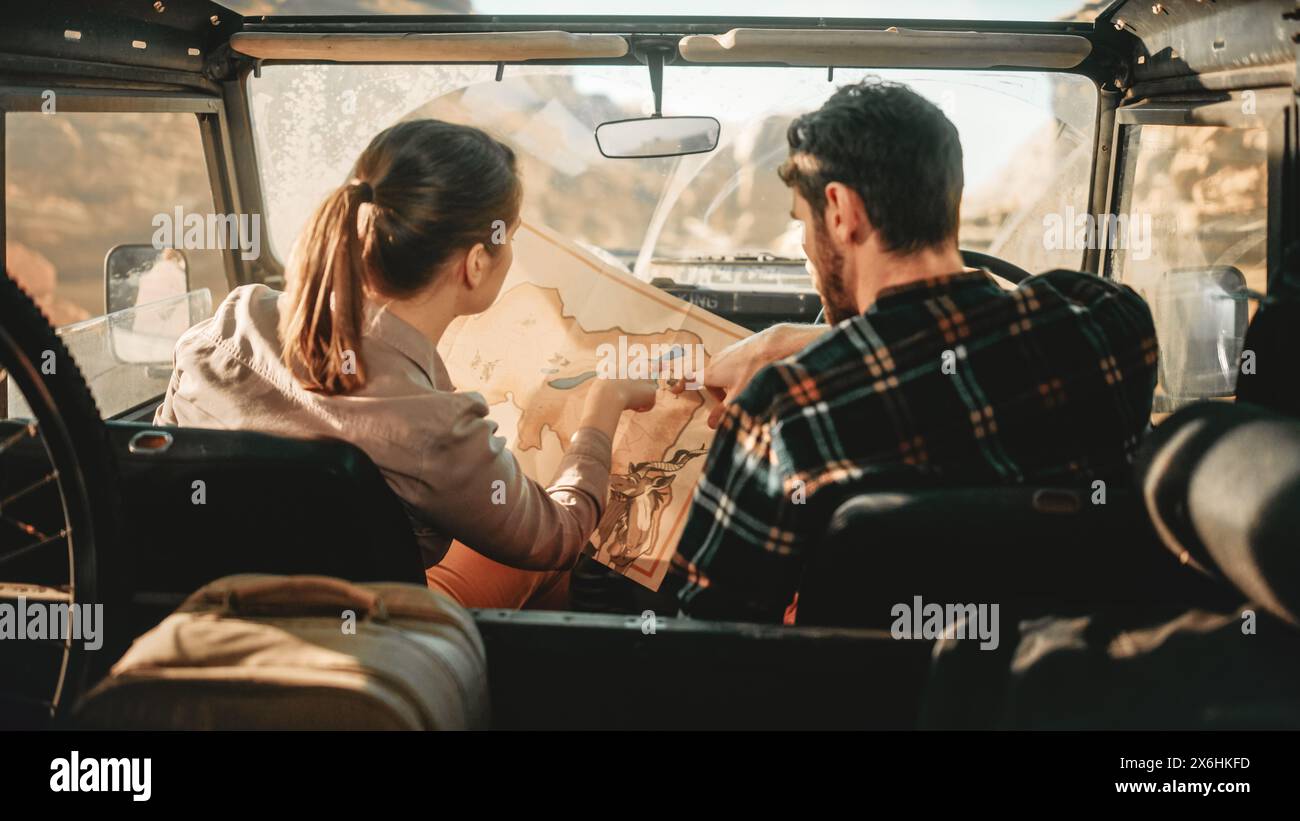 Happy Couple of Tourists Choosing Path with a Map while Driving Off ...