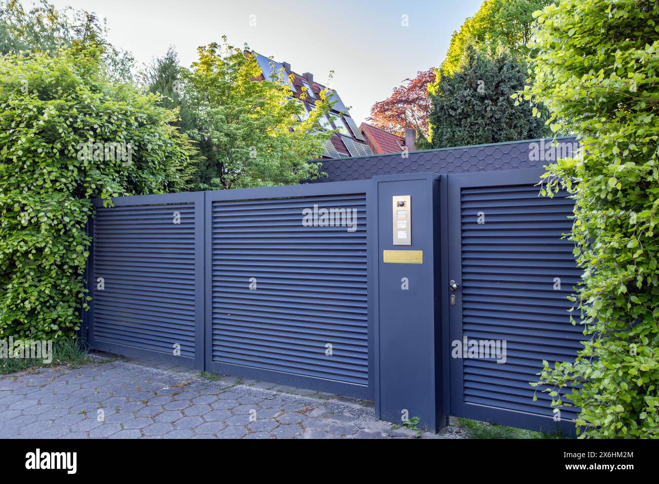 Dark steel property gate with camera surveillance Stock Photo - Alamy