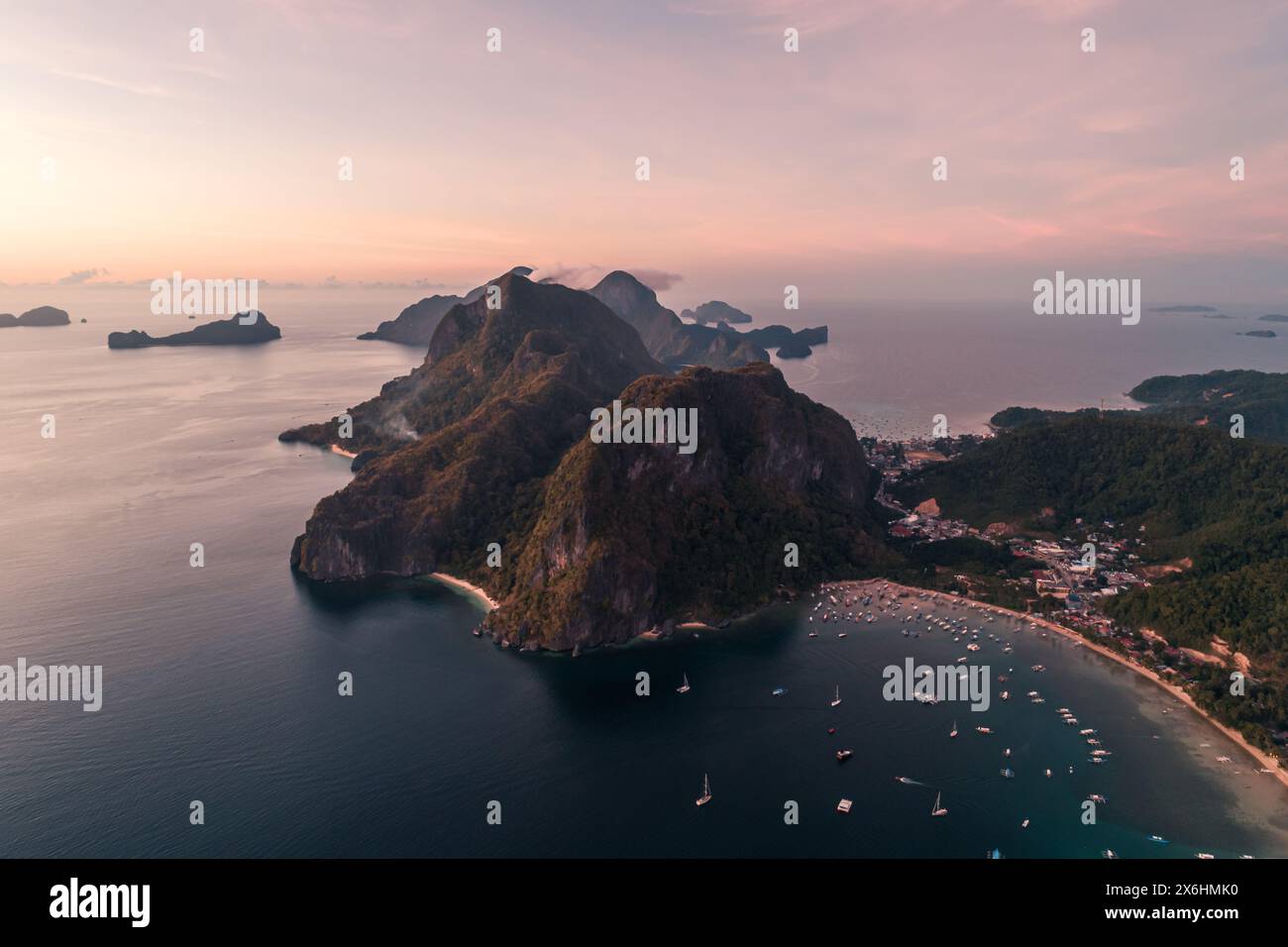 Aerial view of cliffs in the sea, yachts are sailing nearby, mountains ...
